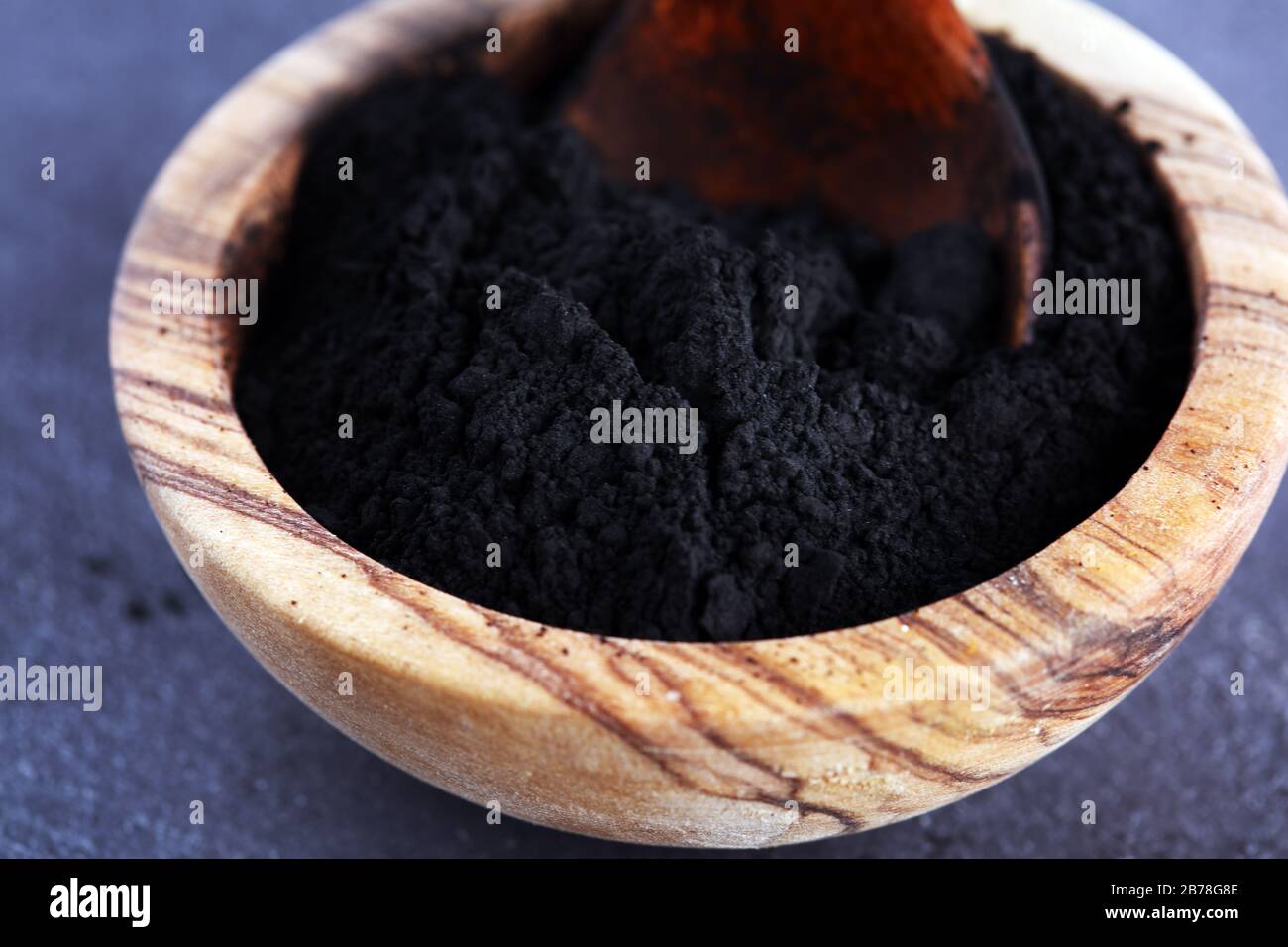 Activated charcoal powder on table for beauty treatment Stock Photo - Alamy