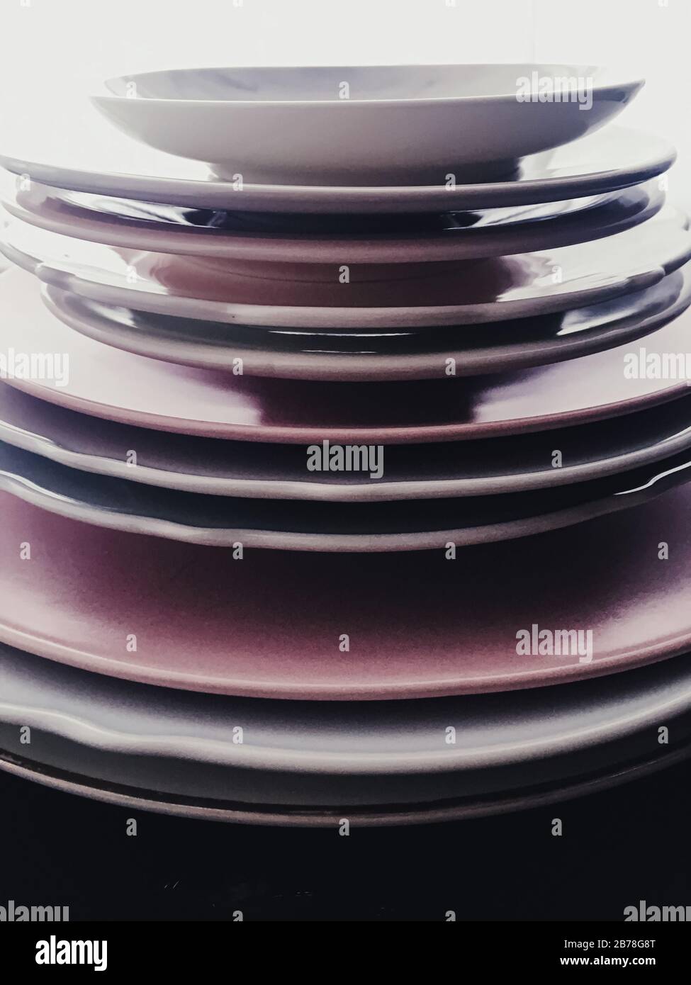 Stack of clean empty plates on black background, luxe dishware and ...