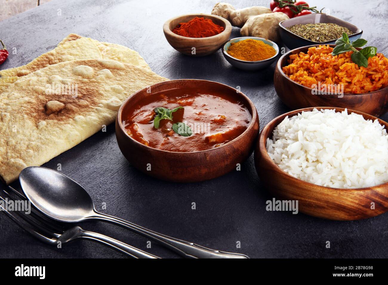 Chicken tikka masala spicy curry meat food in pot with rice and naan ...