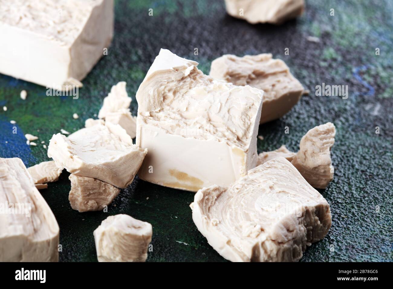 Dry yeast crumbled and yeast block for baking on table Stock Photo - Alamy