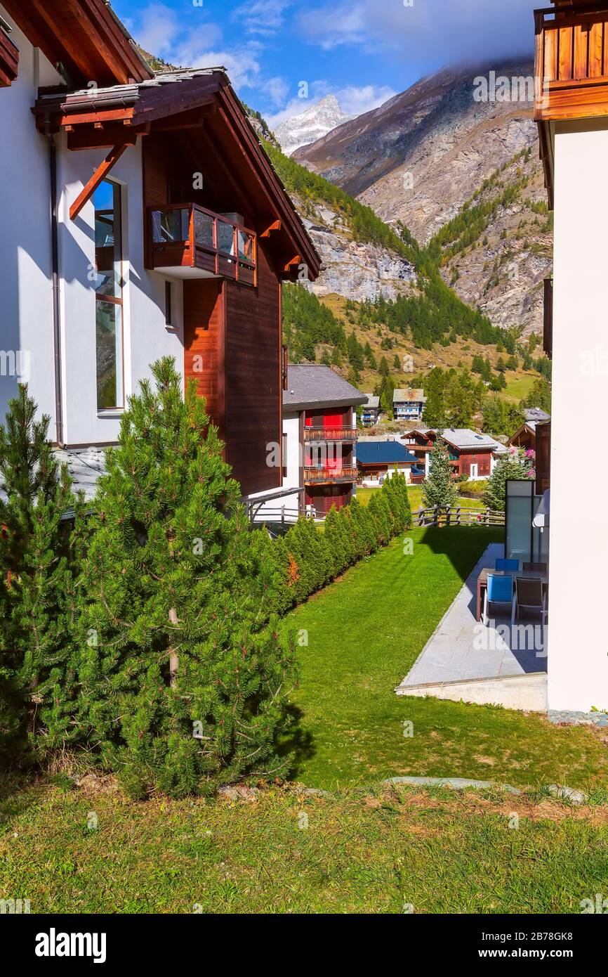 Traditional wooden houses in Zermatt, alpine village street view ...