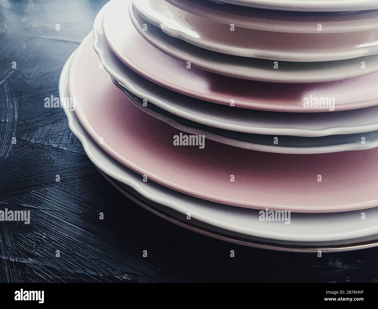Stack of clean empty plates on black background, luxe dishware and ...