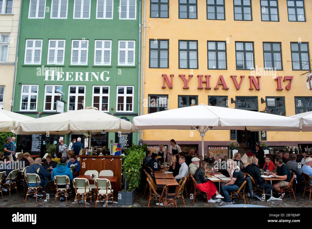 Exterior view of diners and restaurant, Nyhavn, Copenhagen, Denmark ...