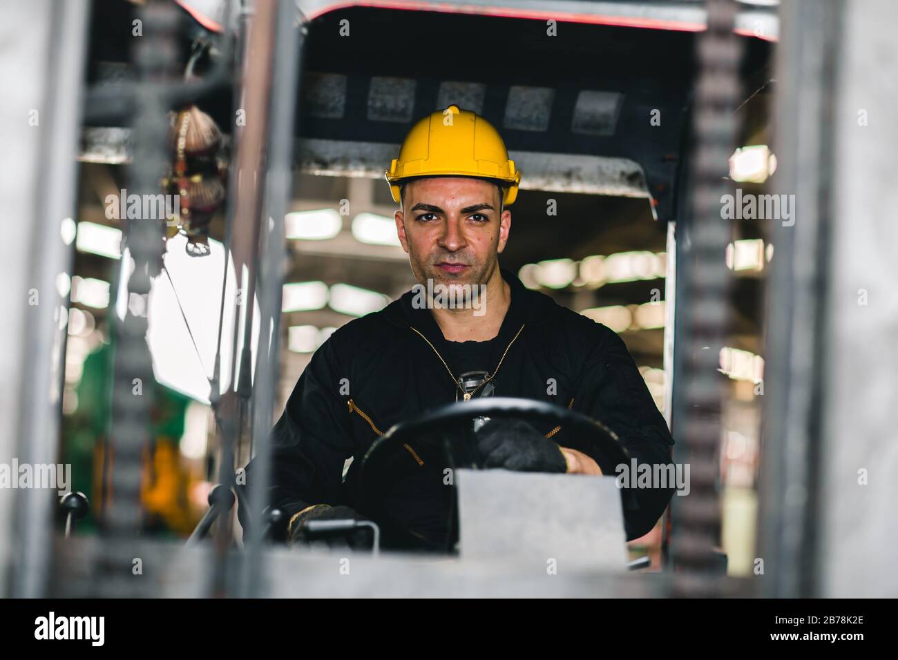 Caucasian factory worker forklift driver in cargo logistic shipping ...