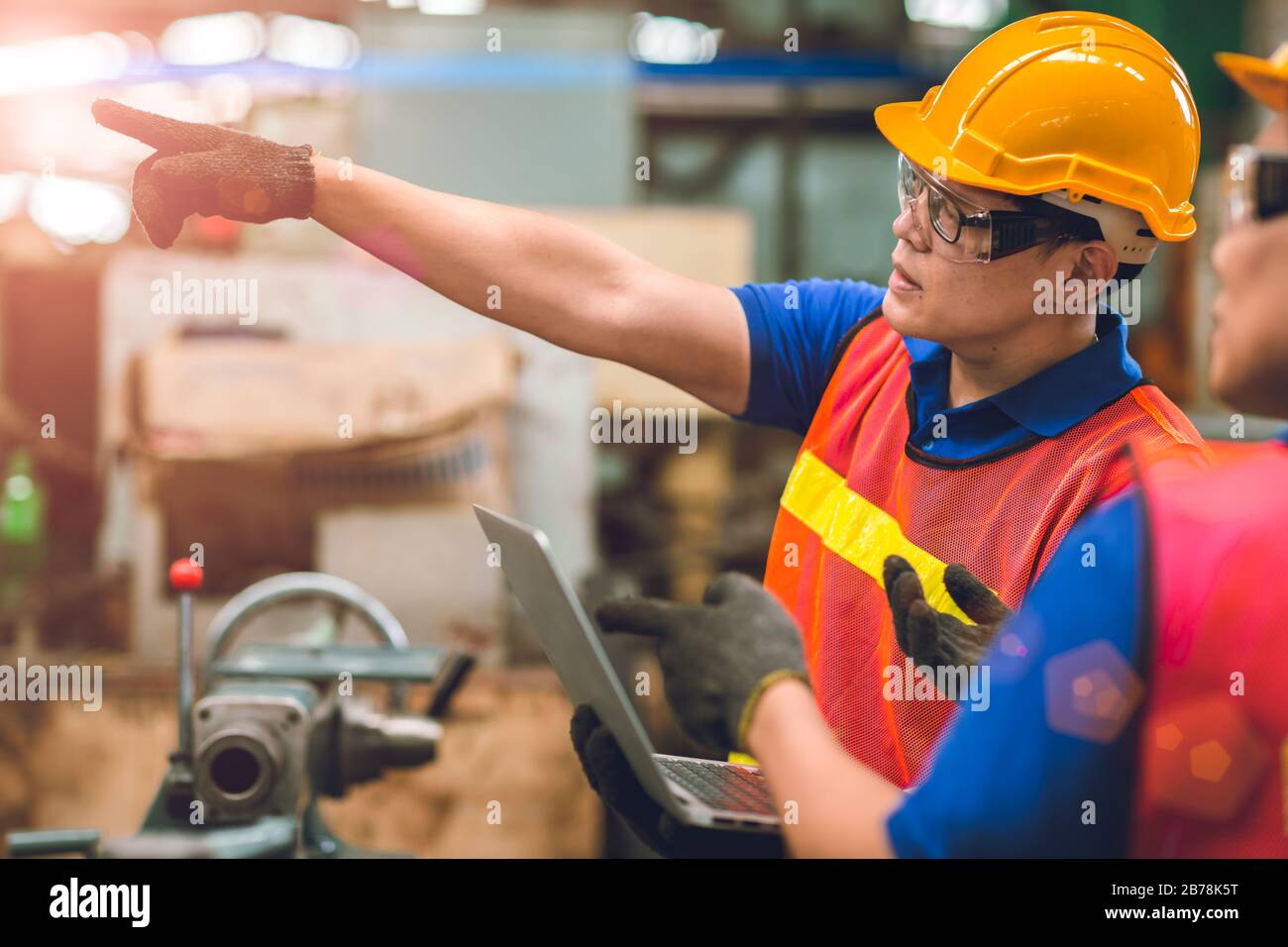 engineer team working together in heavy industry with laptop computer ...
