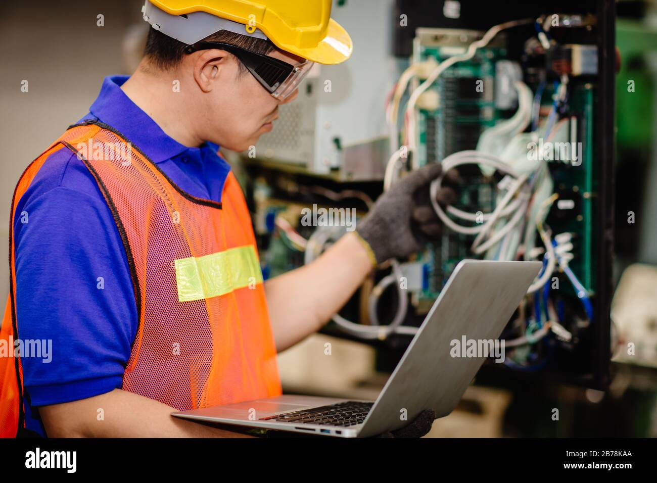 Service engineer team working with electronic wire back panel of heavy ...