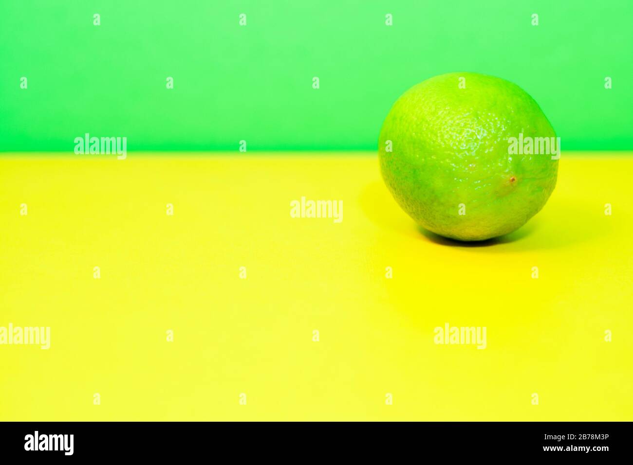 lemon on green and yellow background Stock Photo - Alamy