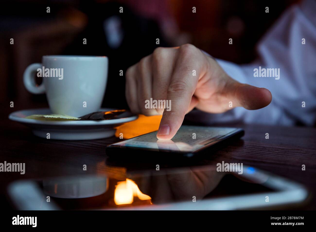 Finger of a Man Touching Phone Screen at the Table in the Restaurant ...