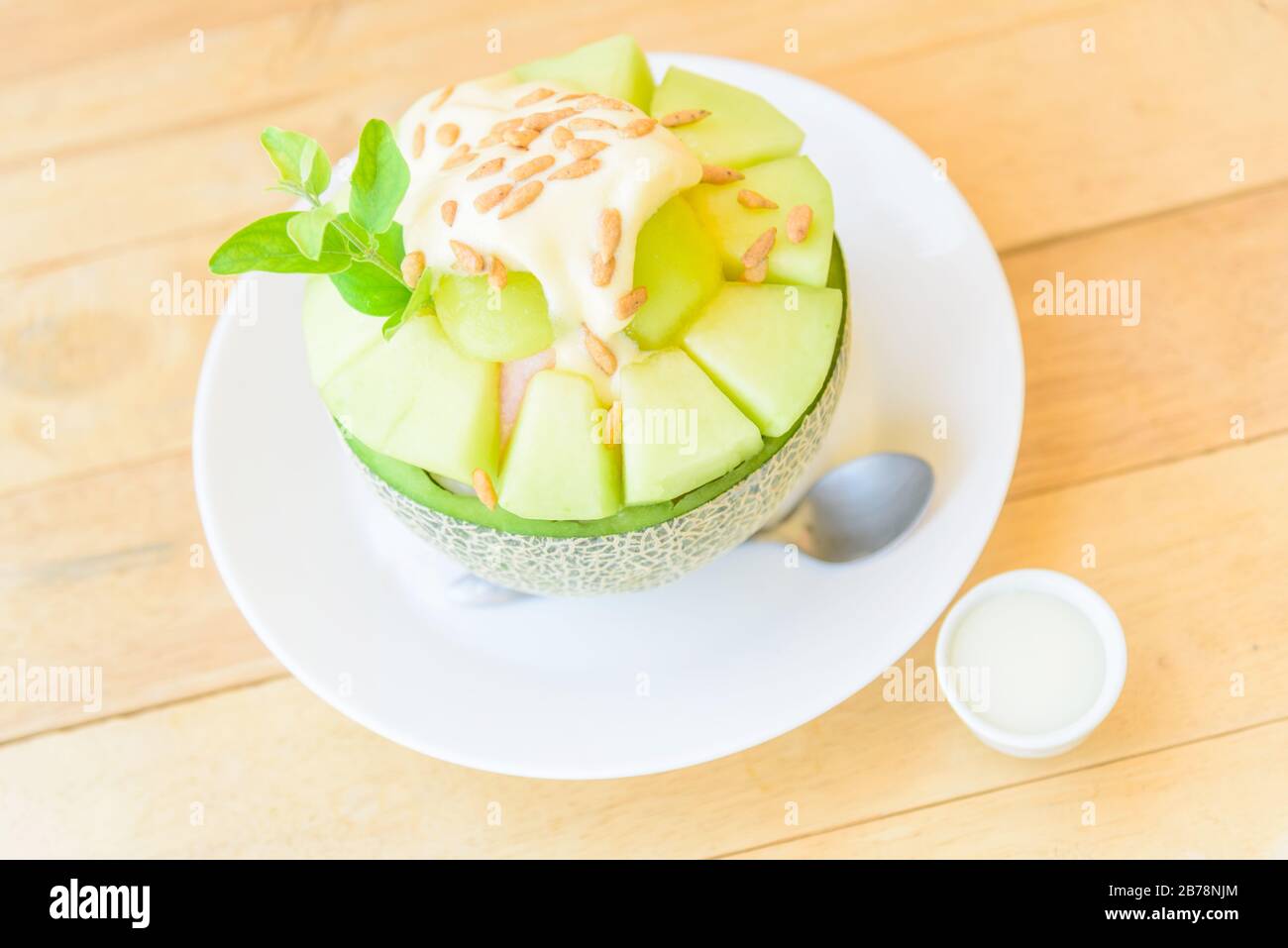 Melon Bingsu with Sweetened Condensed Milk on wood table Stock Photo ...