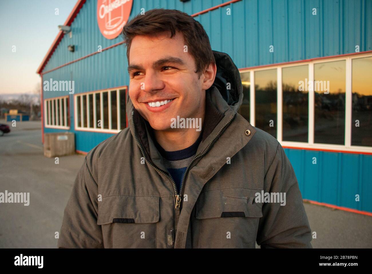 Millennial smiling outside of a icecream shop in winter Stock Photo - Alamy