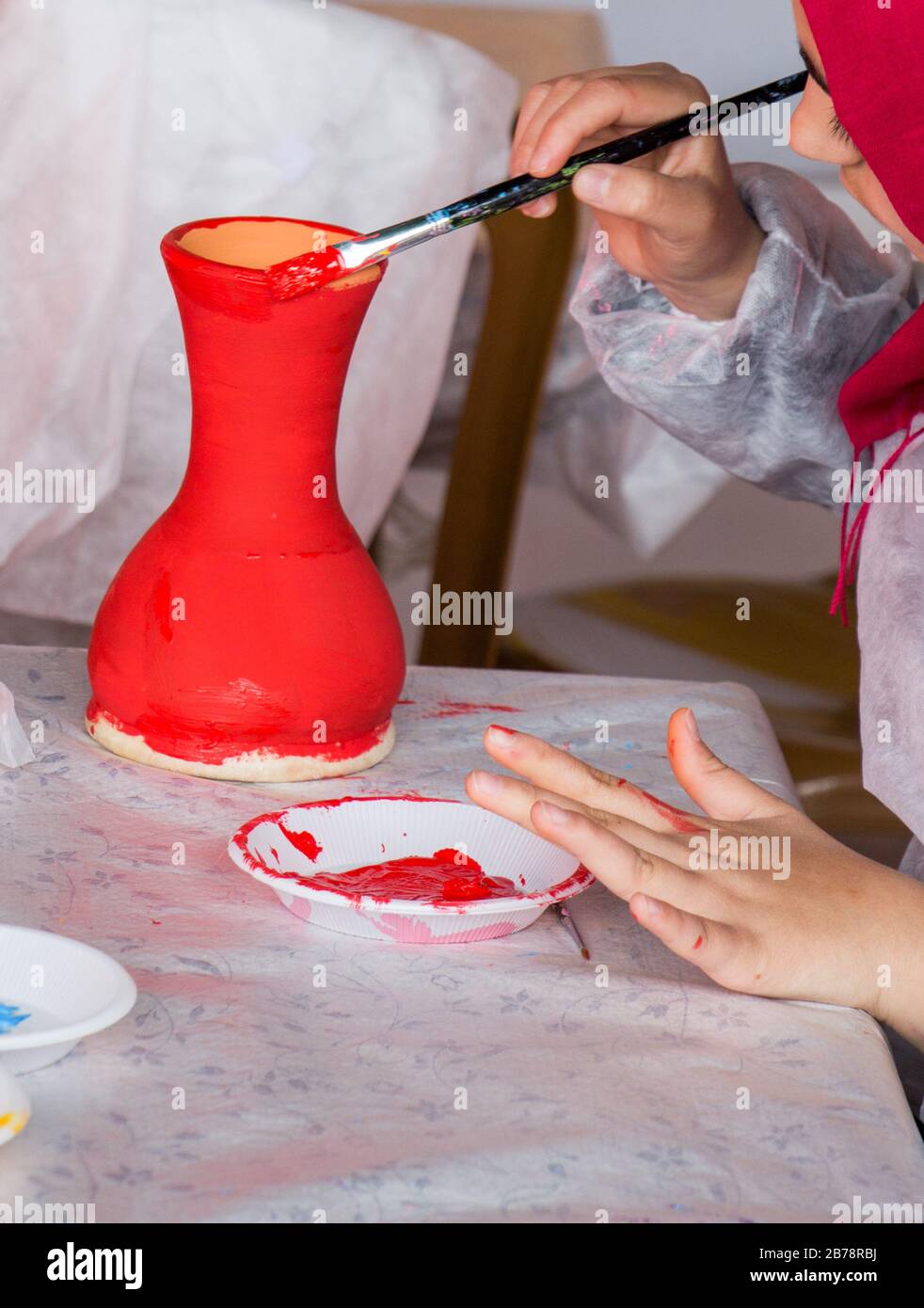 Young children decorating their handmade clay pottery Stock Photo - Alamy