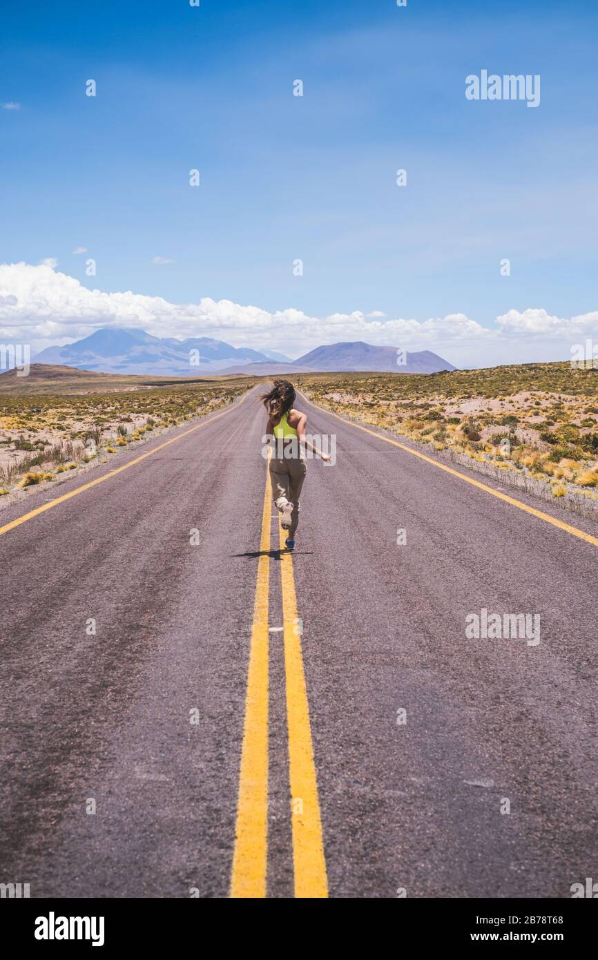 Woman running away on the highway Stock Photo - Alamy