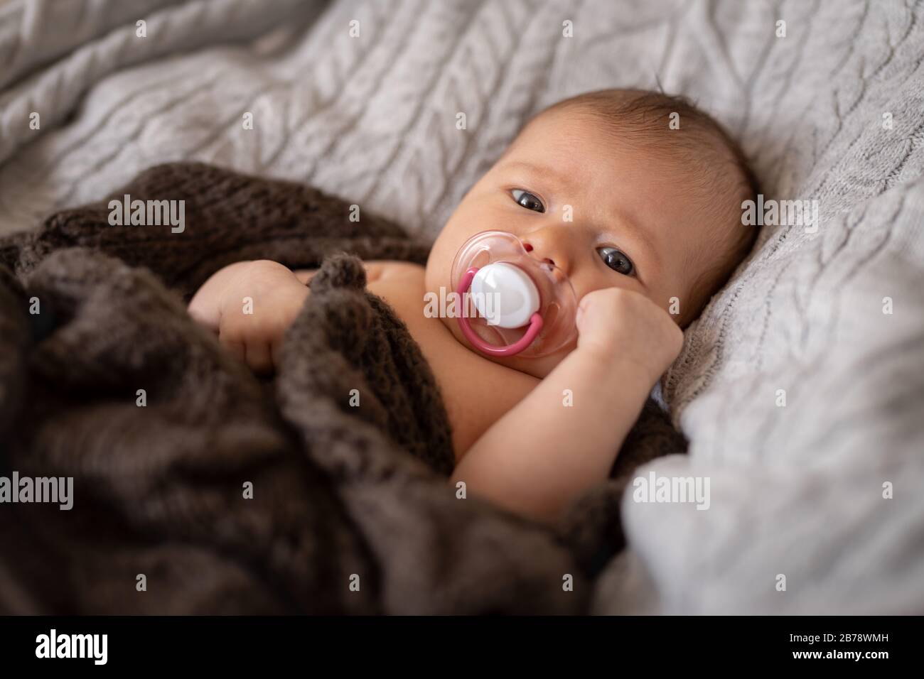 Cute baby pacifier looking camera hi-res stock photography and images ...