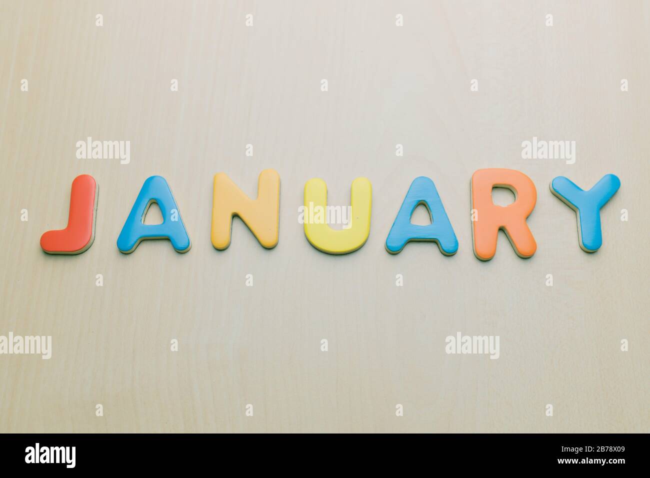 January word written with colorful letters on wooden background, top ...