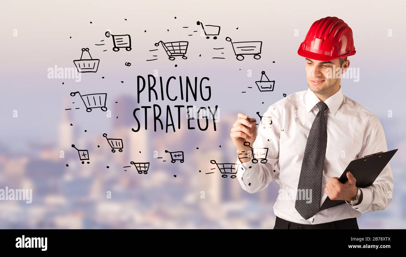 Handsome businessman with helmet drawing PRICING STRATEGY inscription ...
