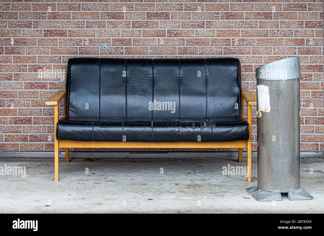 Public smoking area with old sofa chair and cigarette ash bin. Kanazawa ...