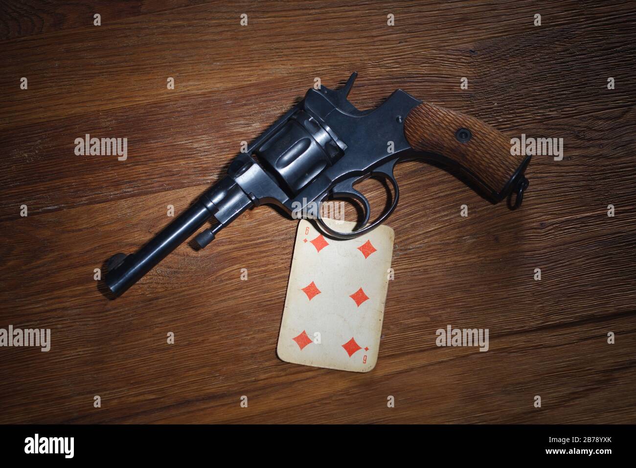 russian roulette - Six of Diamonds plaing card and revolver with one ...