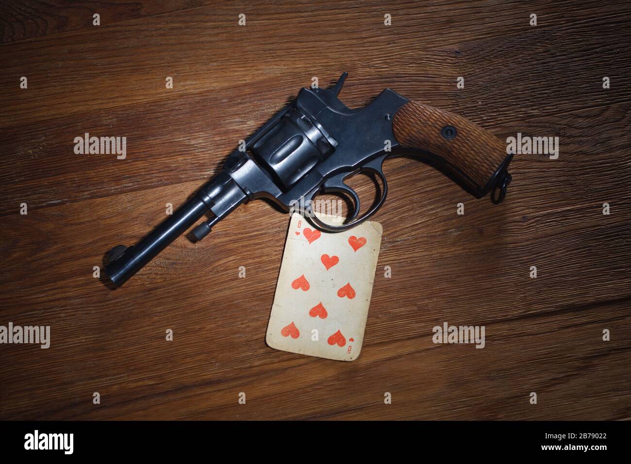 russian roulette - Eight of Hearts plaing card and revolver with one ...