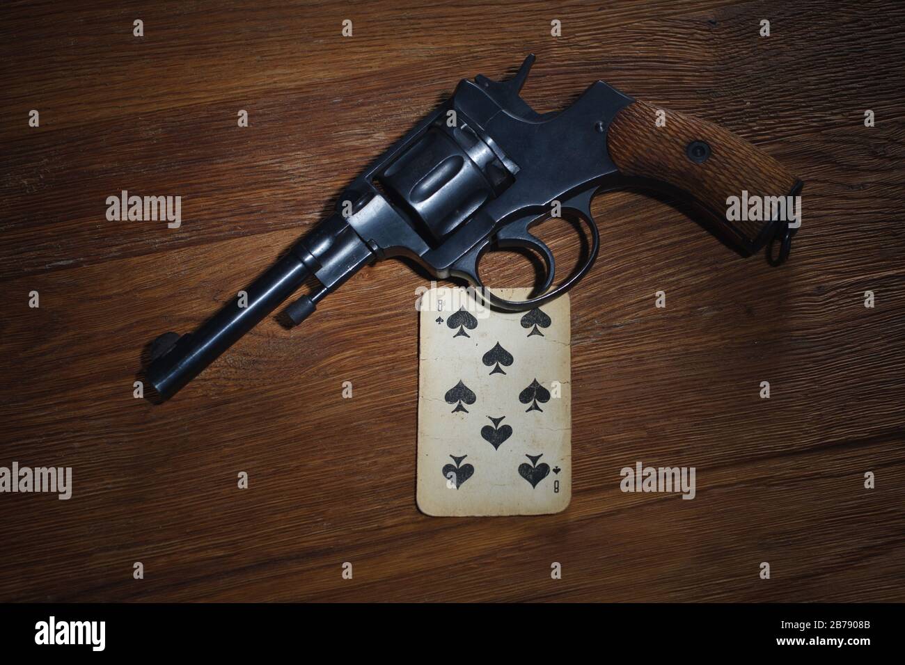 russian roulette - Eight of Spades plaing card and revolver with one ...