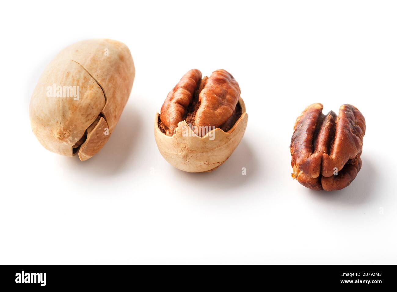 Set of three pecans in the center in a shell, peeled and without a ...