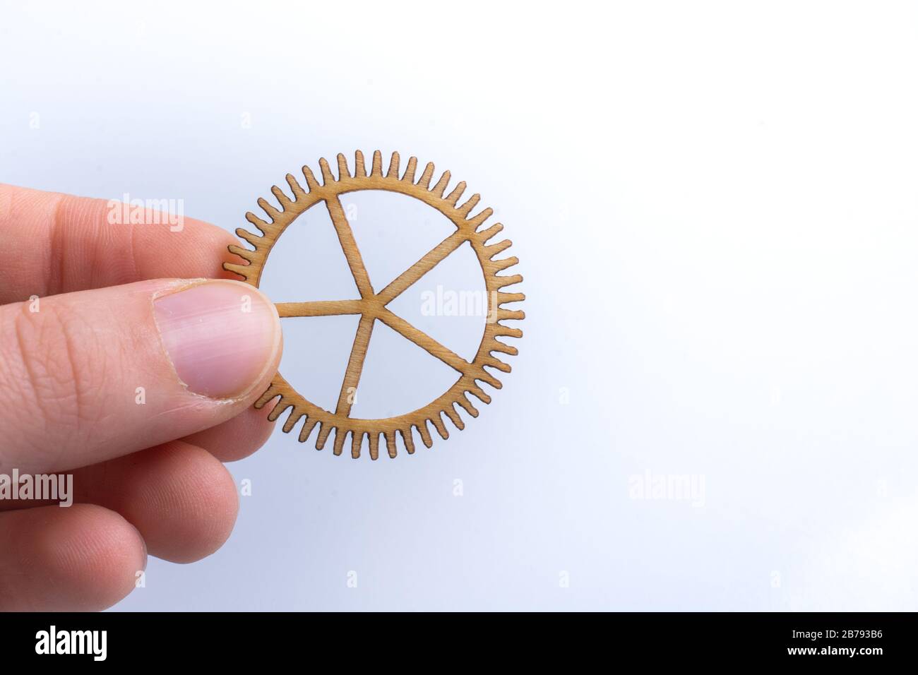 Hand holding gear wheels as the concept of mechanism Stock Photo - Alamy
