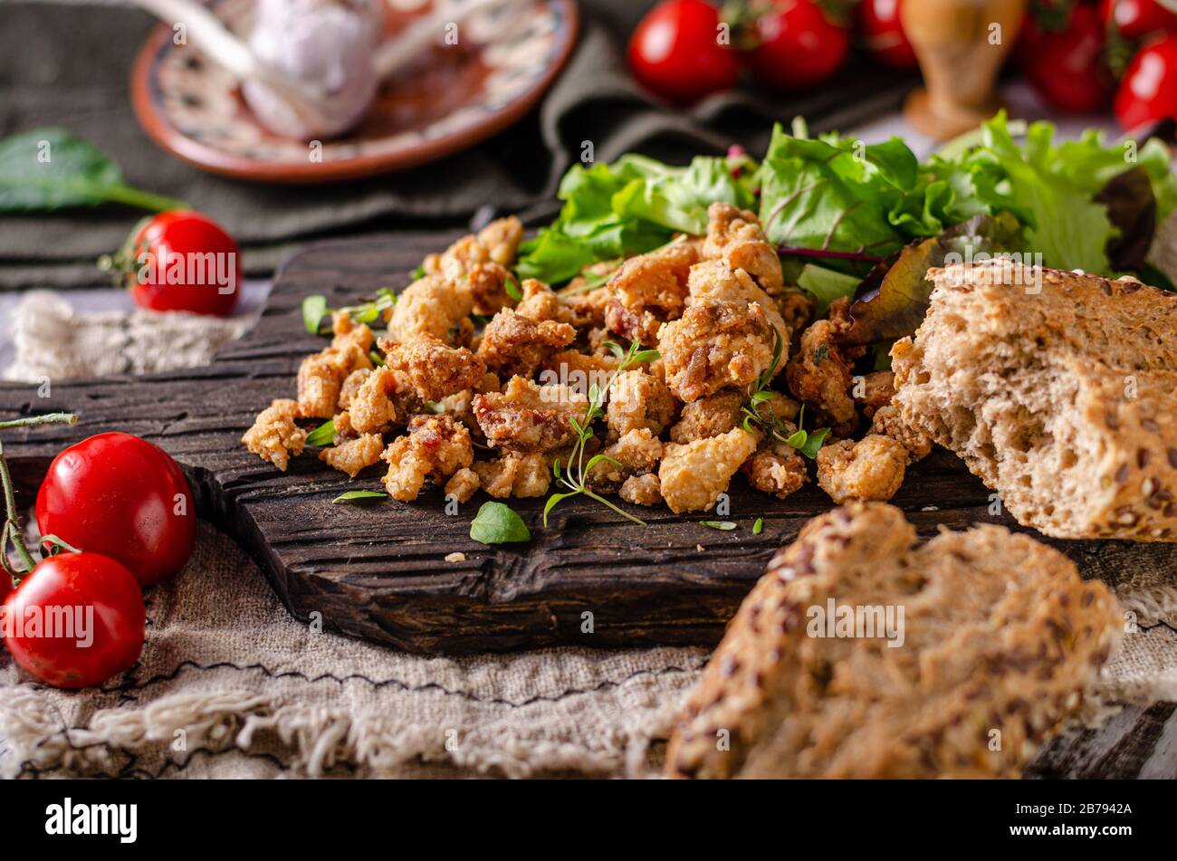 Delicious fat food, fried greaves pork with garlic Stock Photo - Alamy