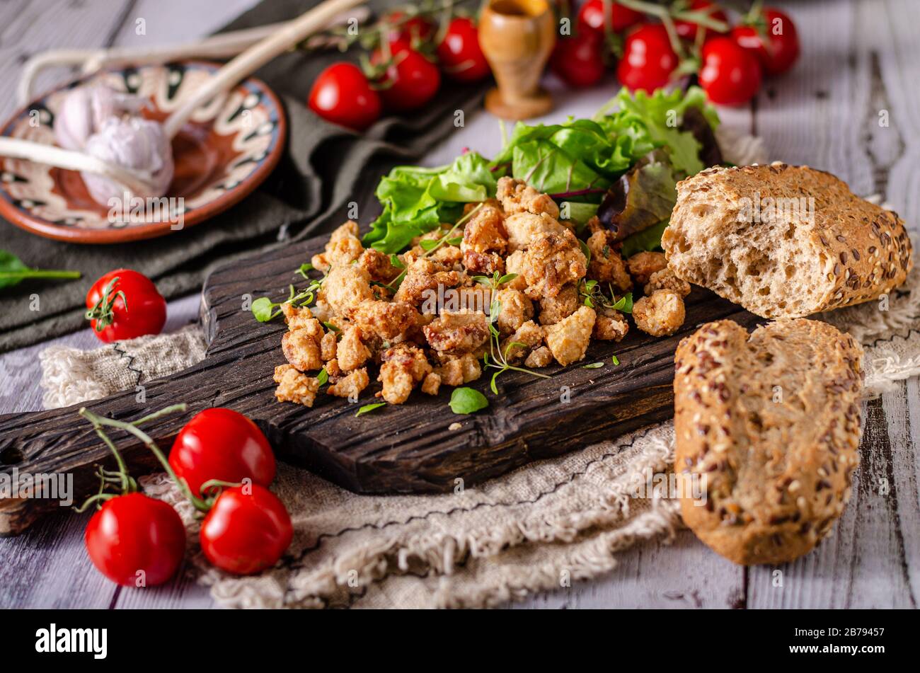 Delicious fat food, fried greaves pork with garlic Stock Photo - Alamy