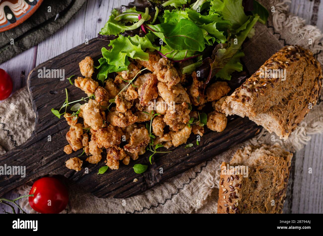 Delicious fat food, fried greaves pork with garlic Stock Photo - Alamy