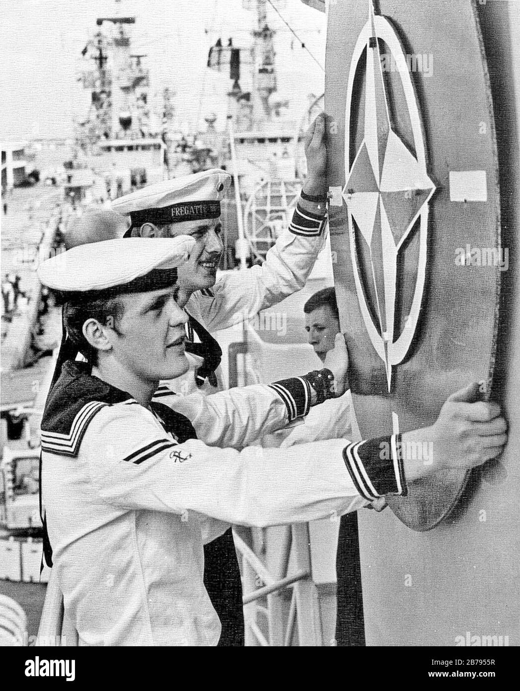German sailors mounting the NATO emblem on the frigate Braunschweig ...