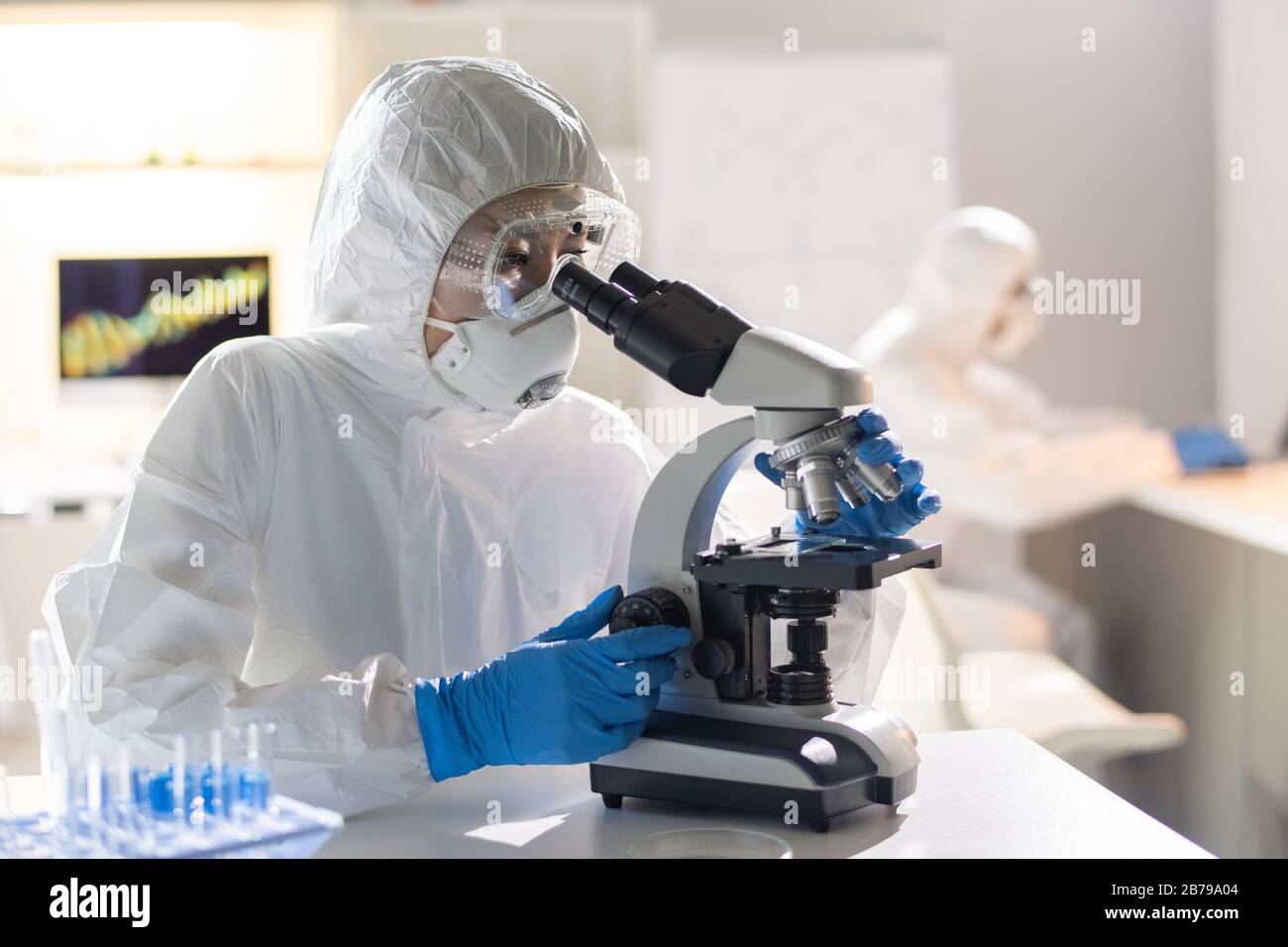 Female lab worker or researcher looking at new chemical element or ...