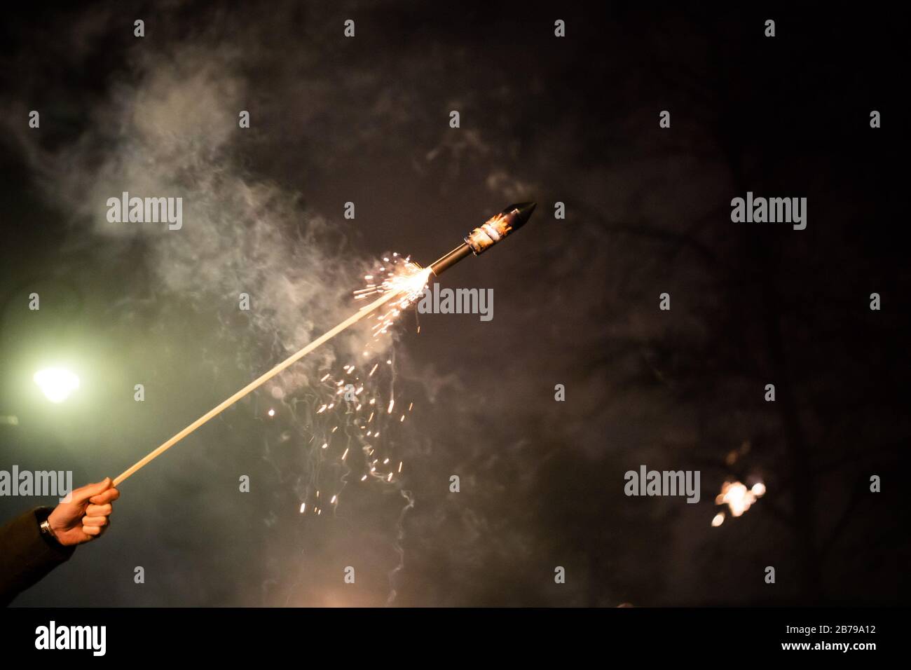 hand with burning firecracker rocket , rather dangerous Stock Photo - Alamy