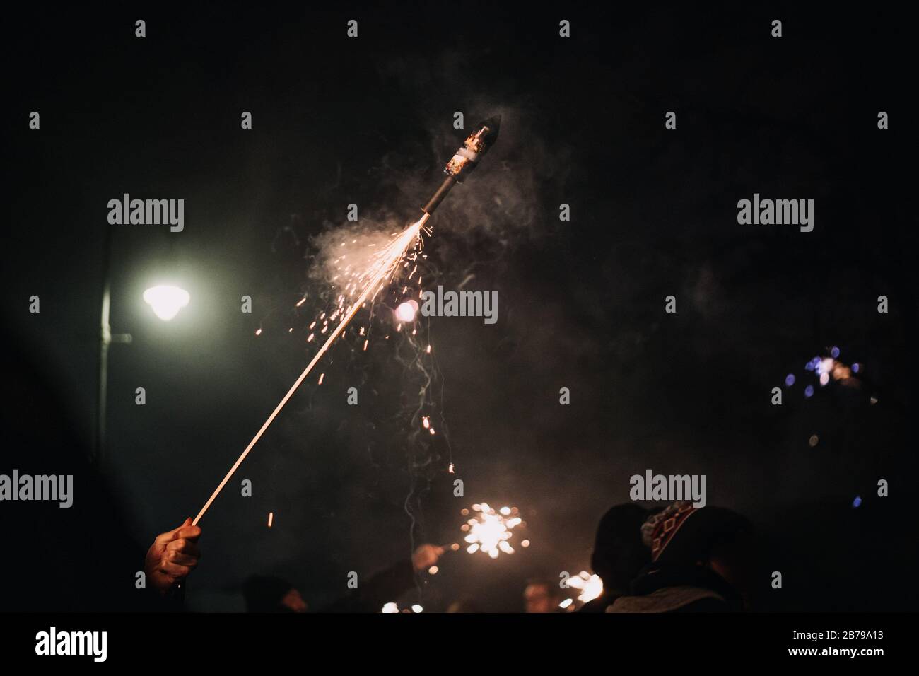 hand with burning firecracker rocket , rather dangerous Stock Photo - Alamy