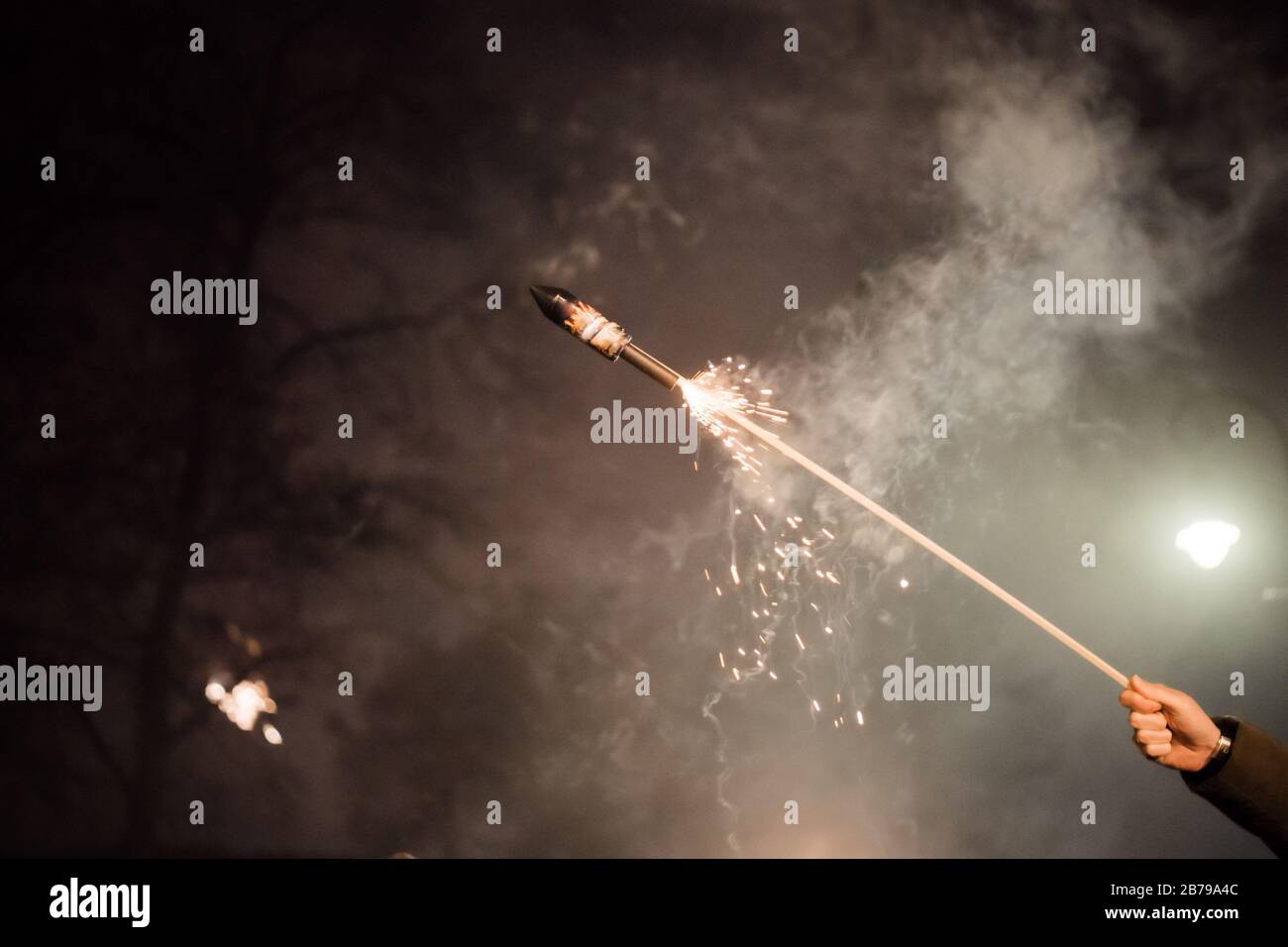 hand with burning firecracker rocket , rather dangerous Stock Photo - Alamy