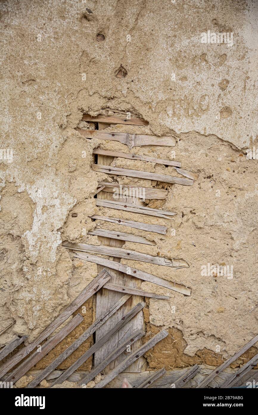 Close up of cracked adobe wall texture, clay wall from a mud house in ...