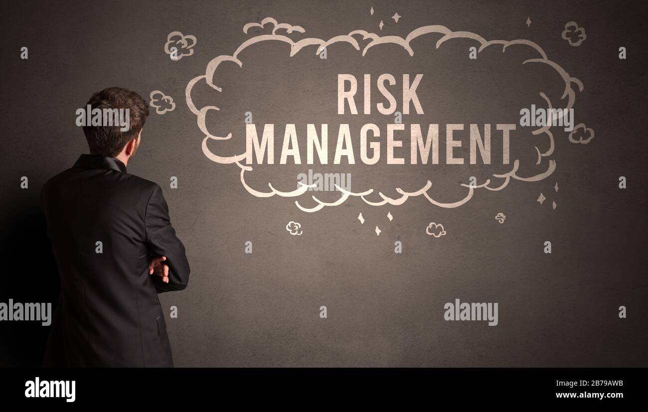 businessman drawing a cloud with RISK MANAGEMENT inscription inside ...