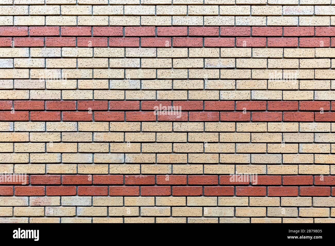 Red and beige painted brick wall background texture close up Stock ...
