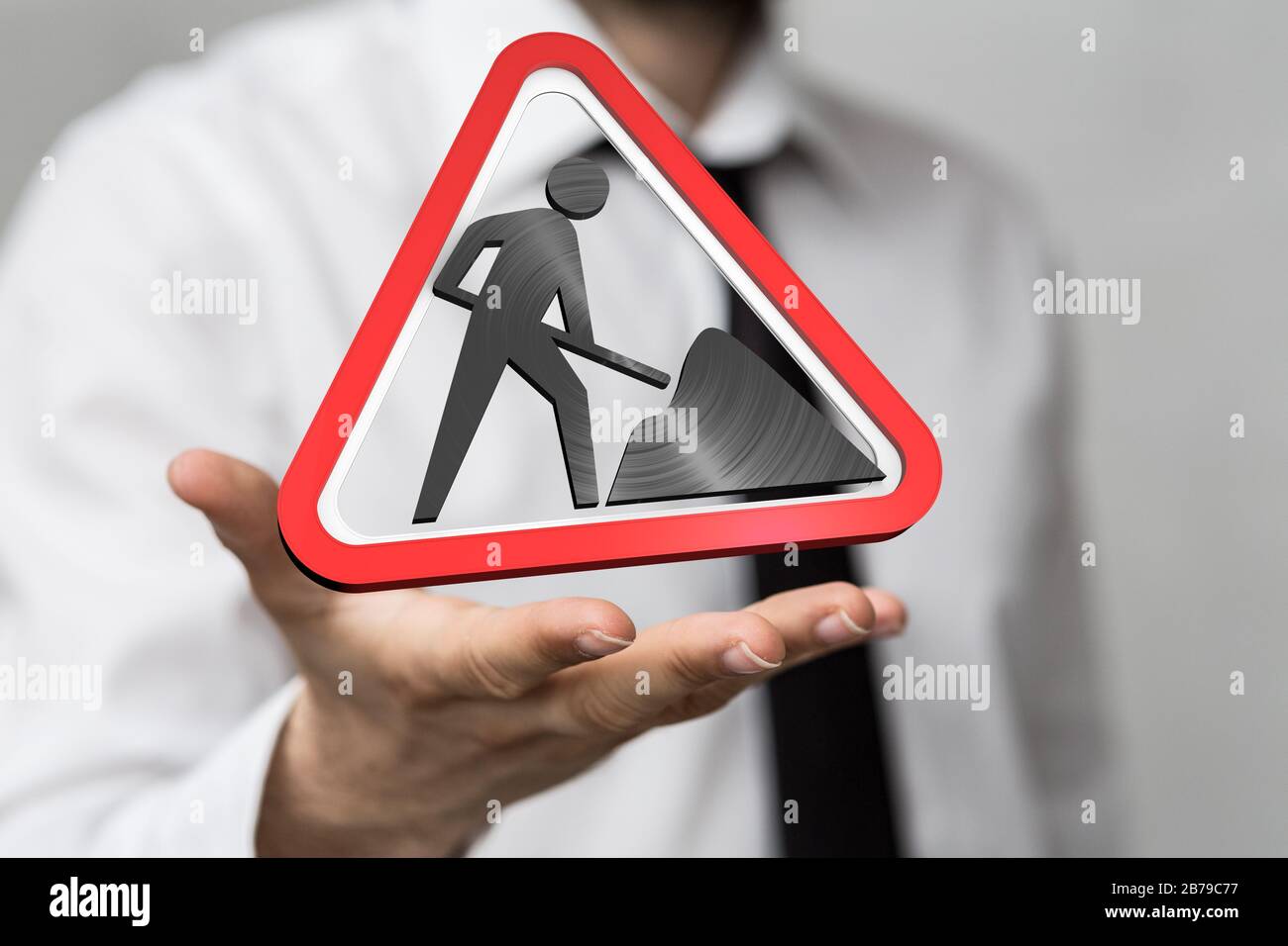A under process sign in hand Stock Photo - Alamy