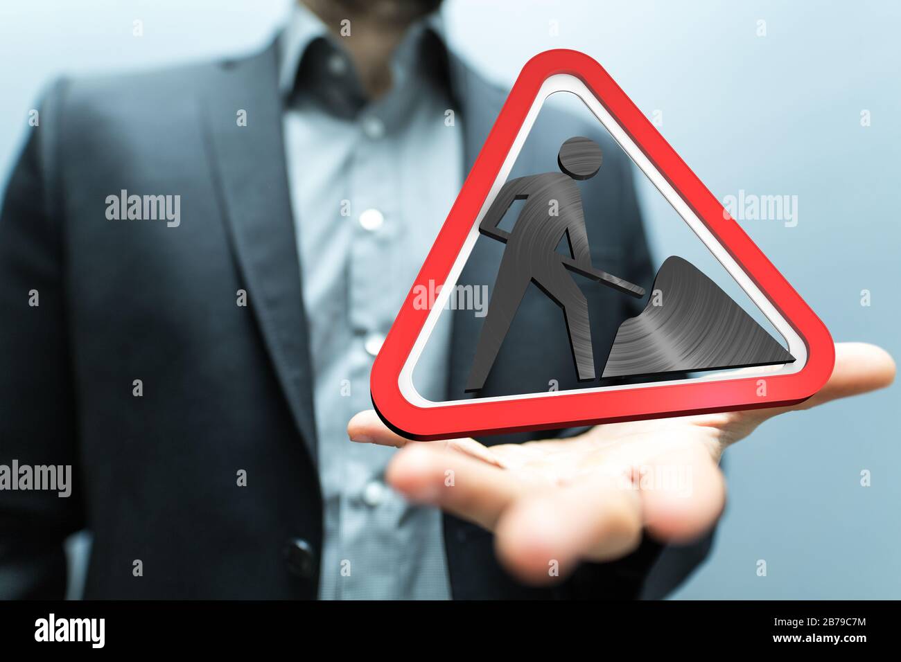 A under process sign in hand Stock Photo - Alamy