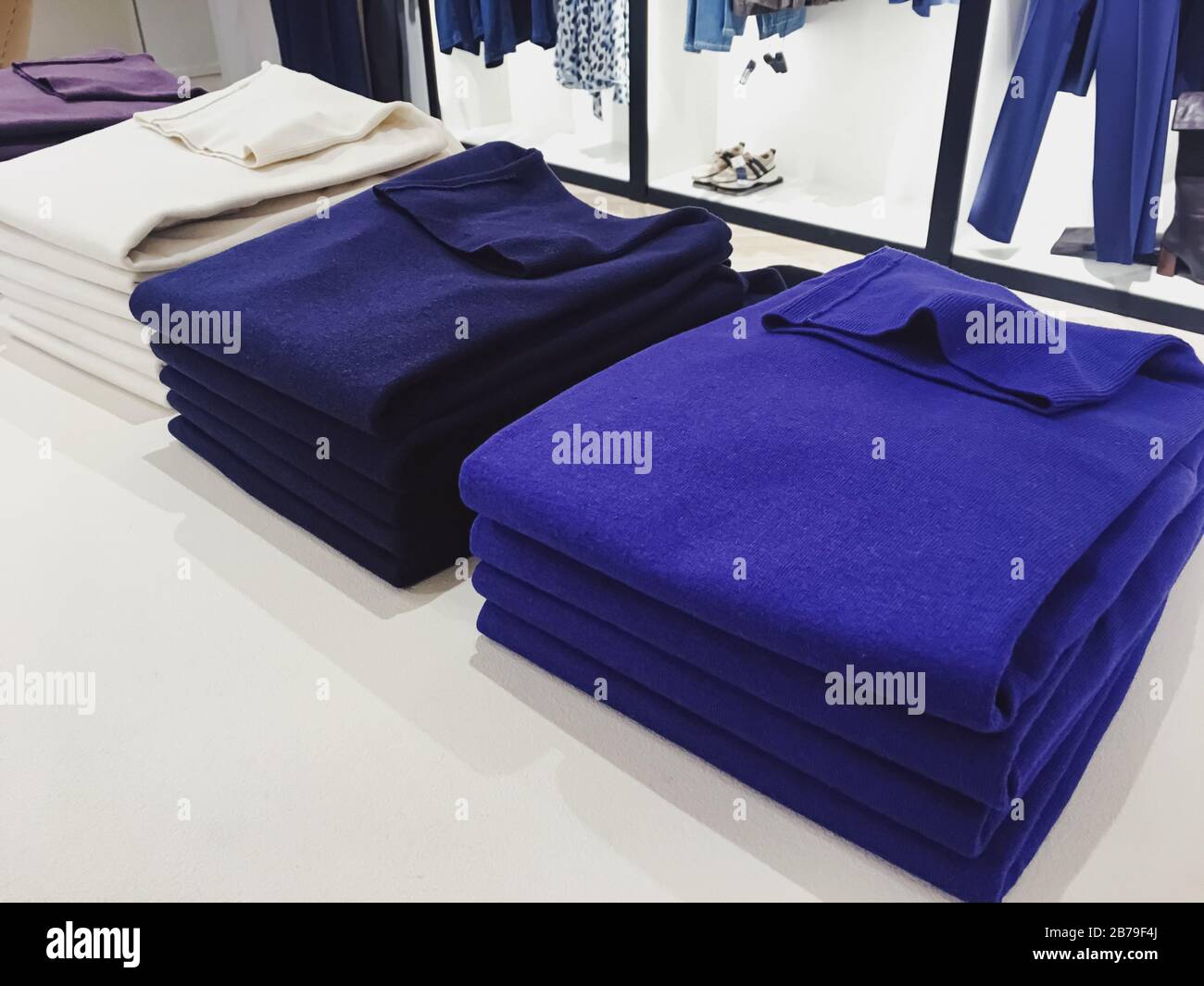 Clothing on display in a boutique store in shopping mall, fast fashion ...