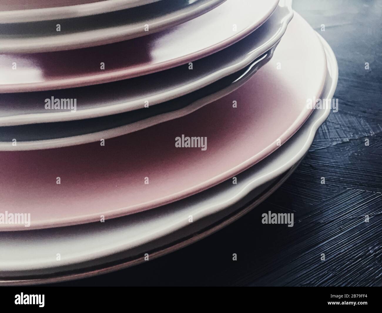 Stack of clean empty plates on black background, luxe dishware and ...