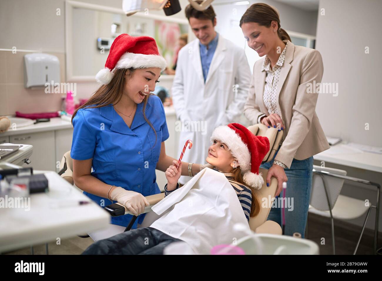 Happy girl at dentist with candy cane for X-mas holiday Stock Photo - Alamy