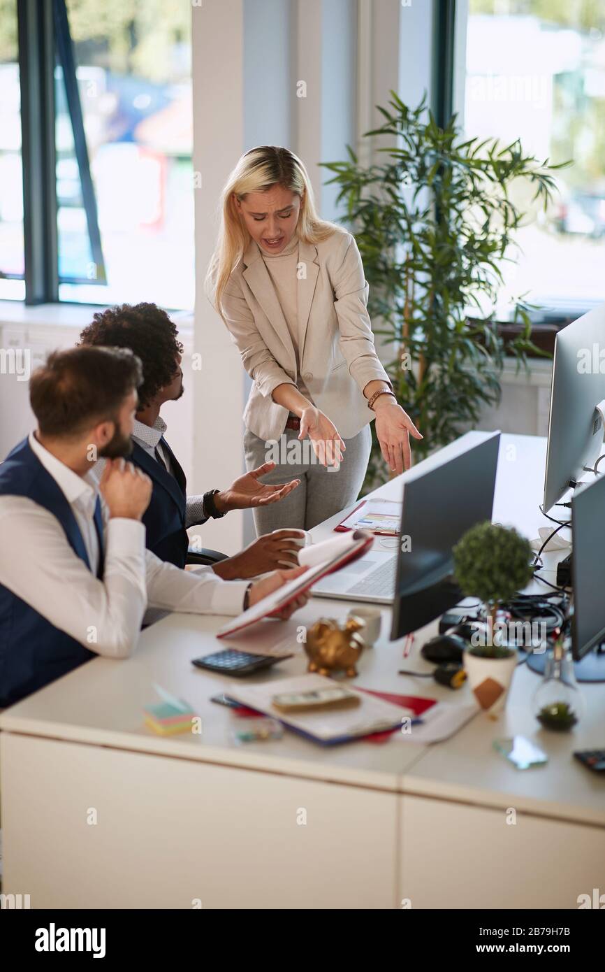 Angry team manager woman with young employees working together Stock ...