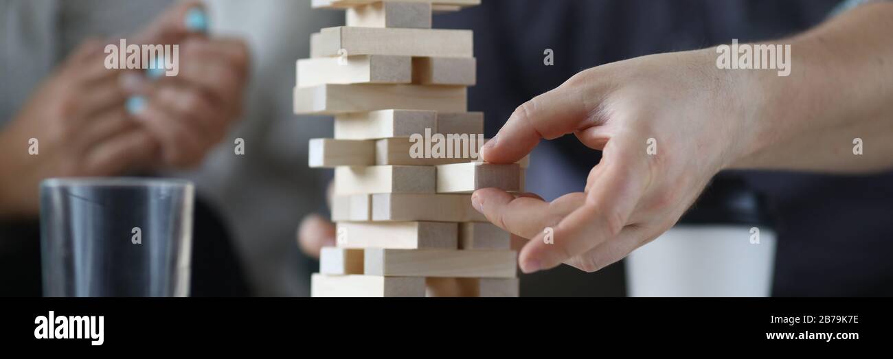 Couple build tower from wood block Stock Photo - Alamy