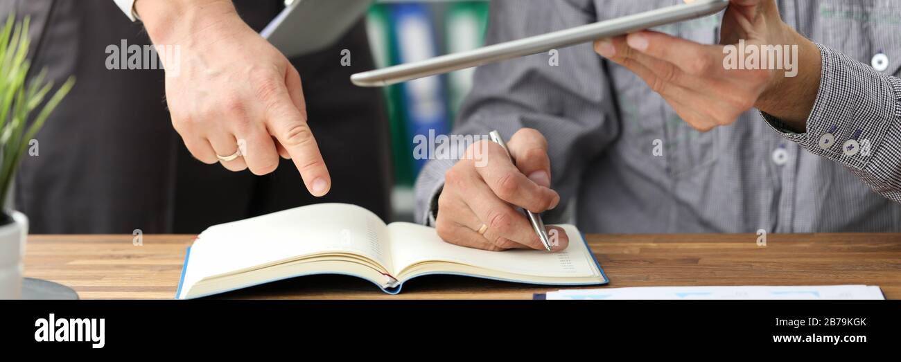 Two business male persons solving document problem Stock Photo - Alamy