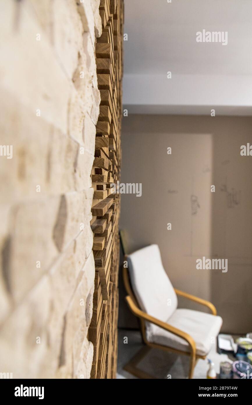Vertical shot of a white chair inside a room with a brick wall and a ...