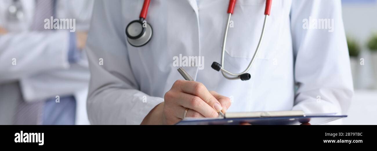 Doctor signing documents Stock Photo - Alamy