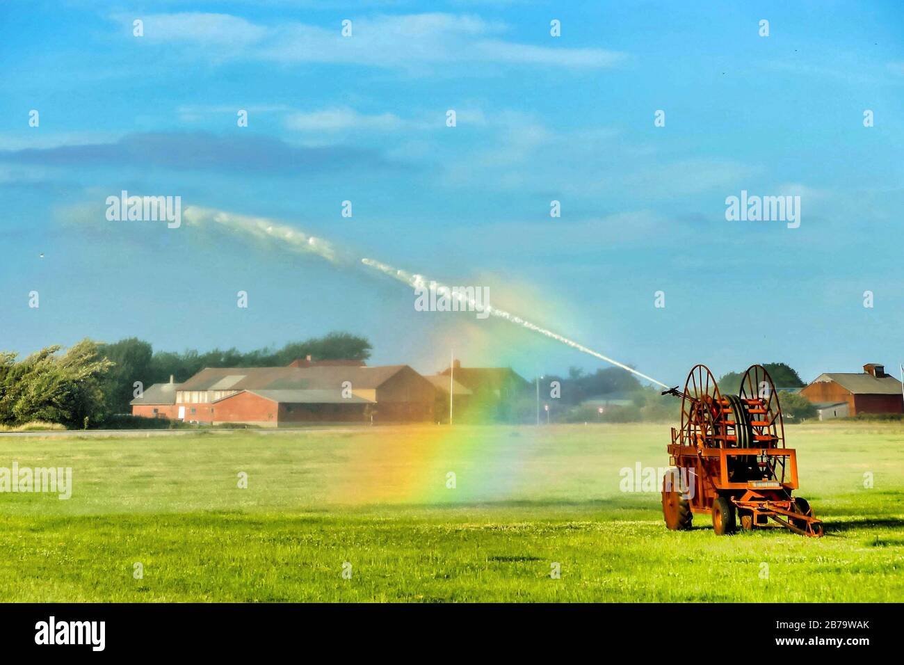 Beautiful shot of a rainbow forming from a water sprinklers Stock Photo ...