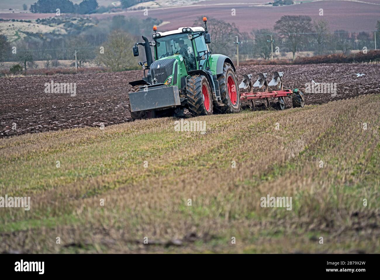 Landscape of tractor and plough, ploughing a field in Angus, Scotland ...