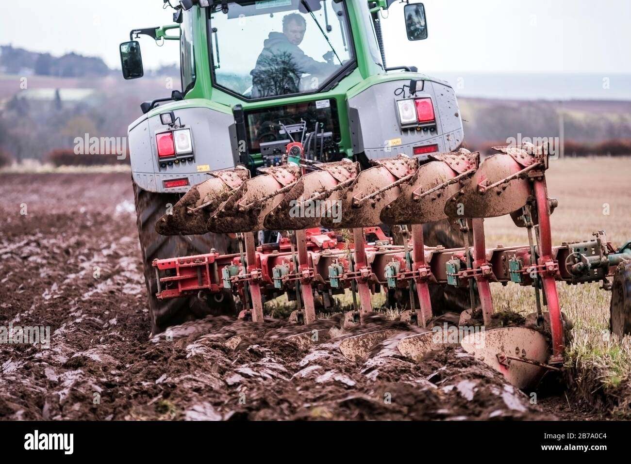 Landscape of tractor and plough, ploughing a field in Angus, Scotland ...
