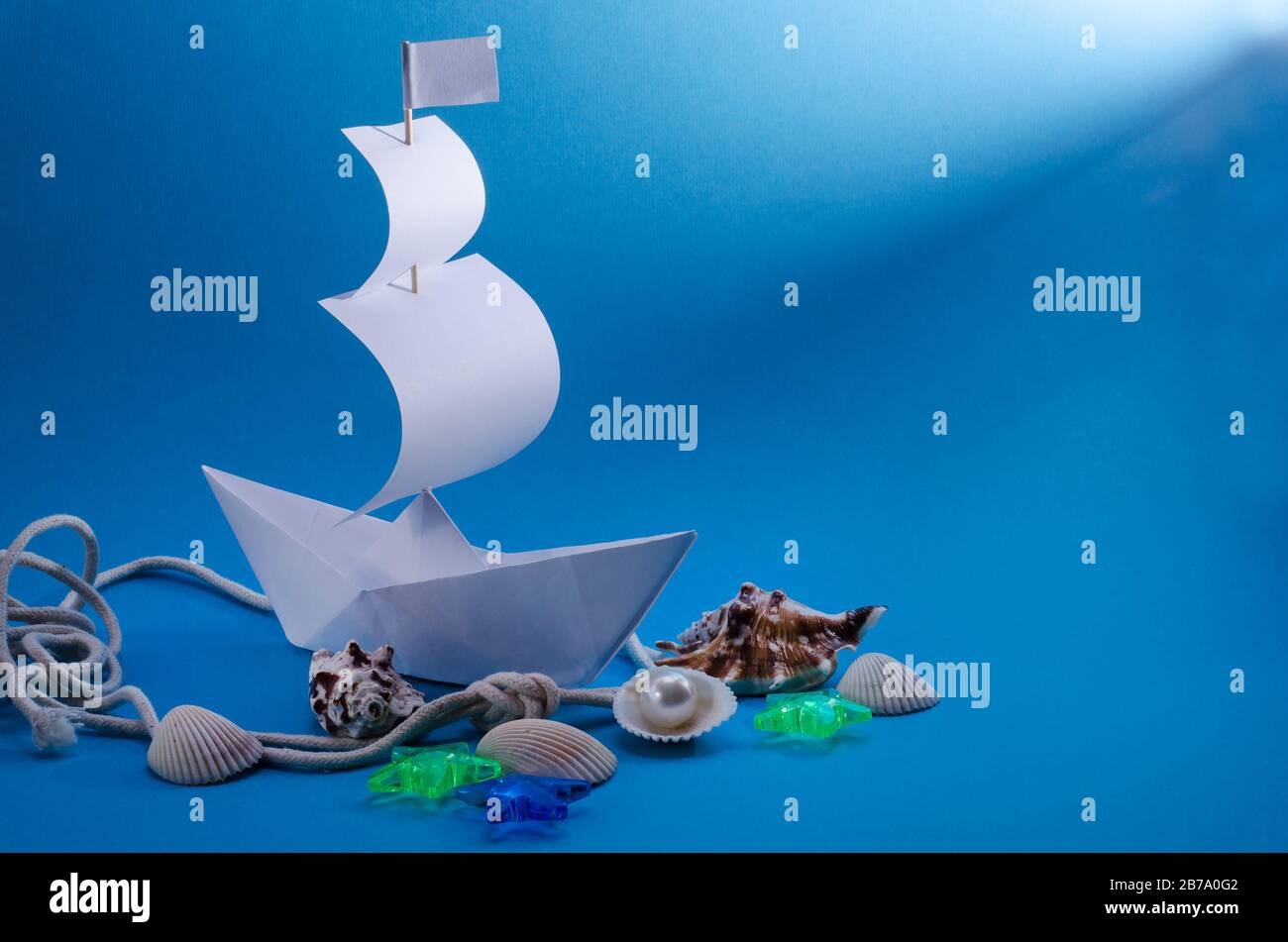Happy Columbus Day. White paper boat on a blue background with copy ...